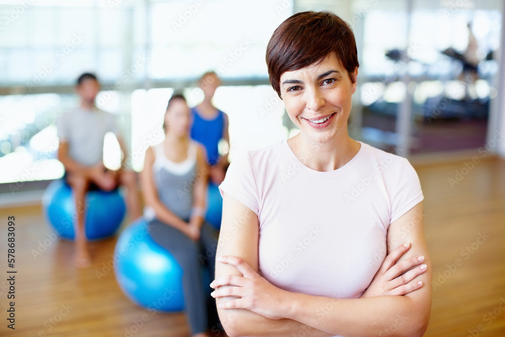 Beautiful female trainer with hands folded. Portrait of smiling female ...