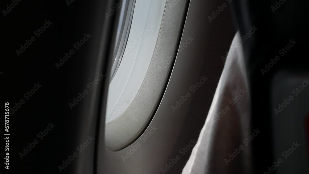 view inside plane cabin to the window with sunlight shine through plane ...