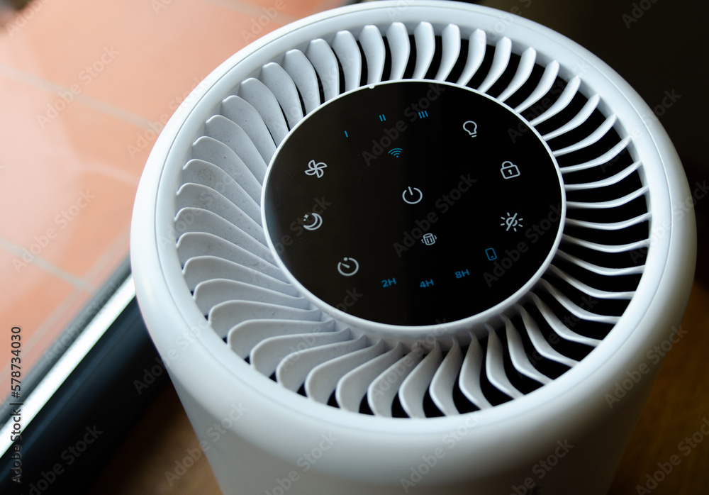 Clean and fresh air with the white air purifier next to the window ...