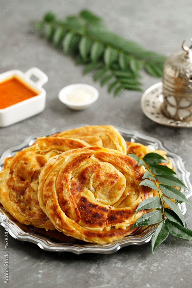 Roti Parata or Roti Canai with Chicken Curry Sauce Stock Photo | Adobe ...