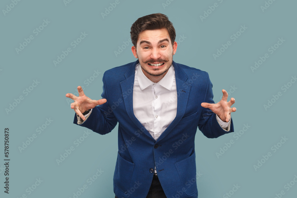 Angry aggressive attractive man standing clenched hid hands, screaming ...