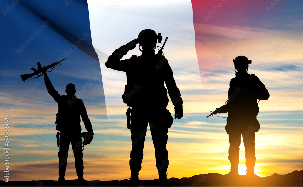 Silhouettes of French soldiers on background of sunset and French flag ...