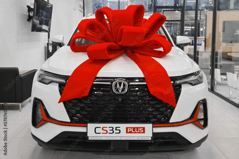 New white Chinese car changan cs35 with a red bow in a car dealership ...