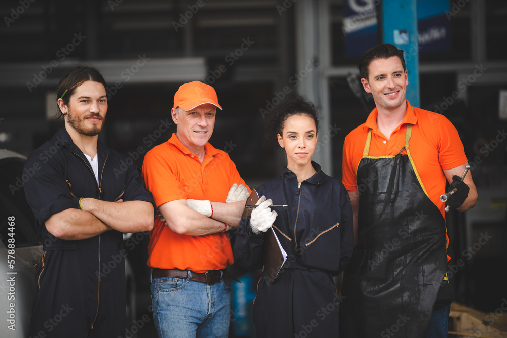 Group of young and senior male and female car mechanics wearing uniform ...