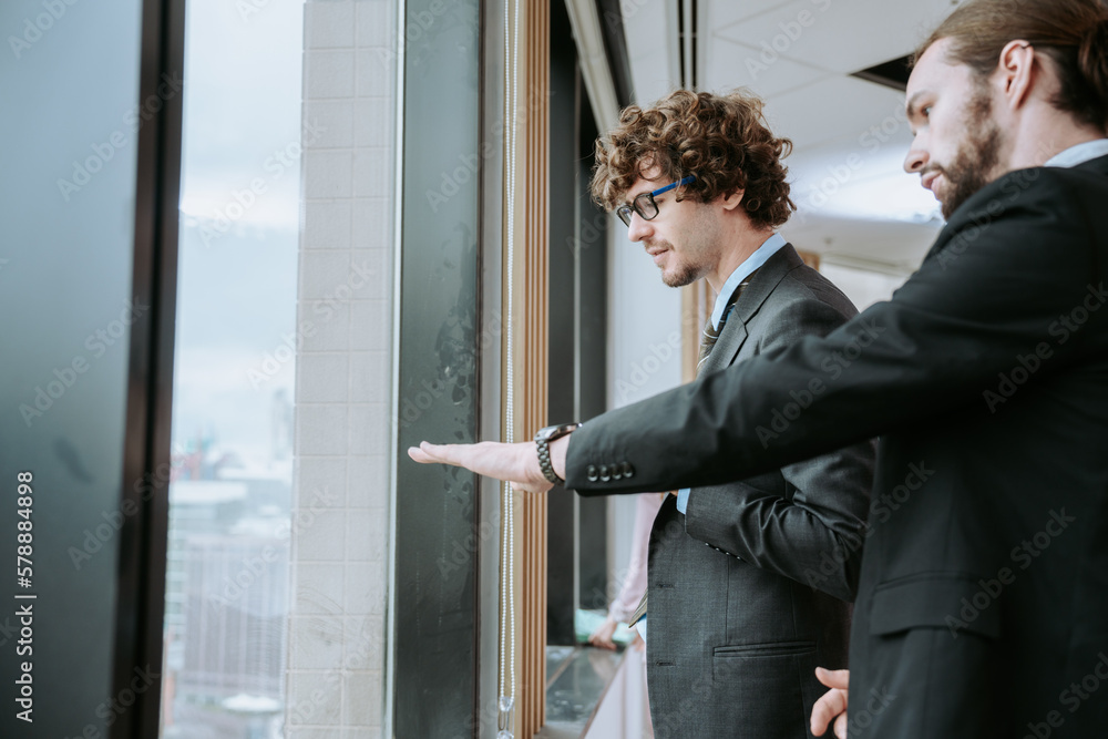 Scoping out the business district skyline, Business colleagues looking ...