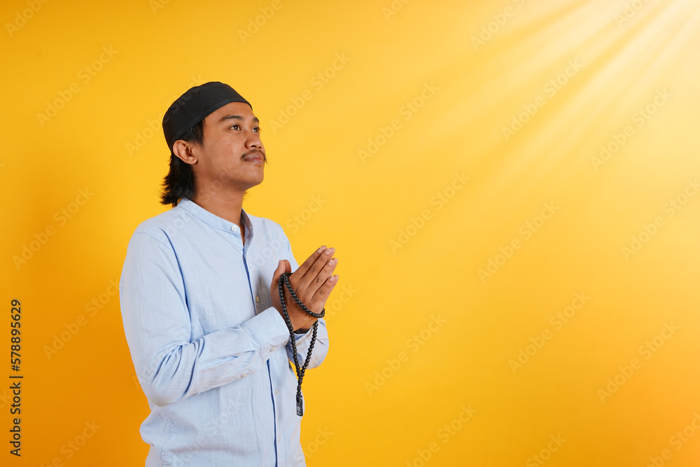 The photo of a young Asian man smiling and paying respect with his ...