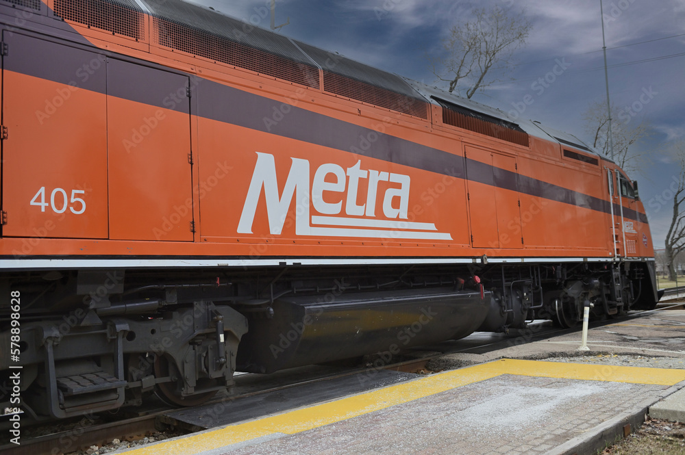 A Metra locomotive departing from the local station with a commuter ...