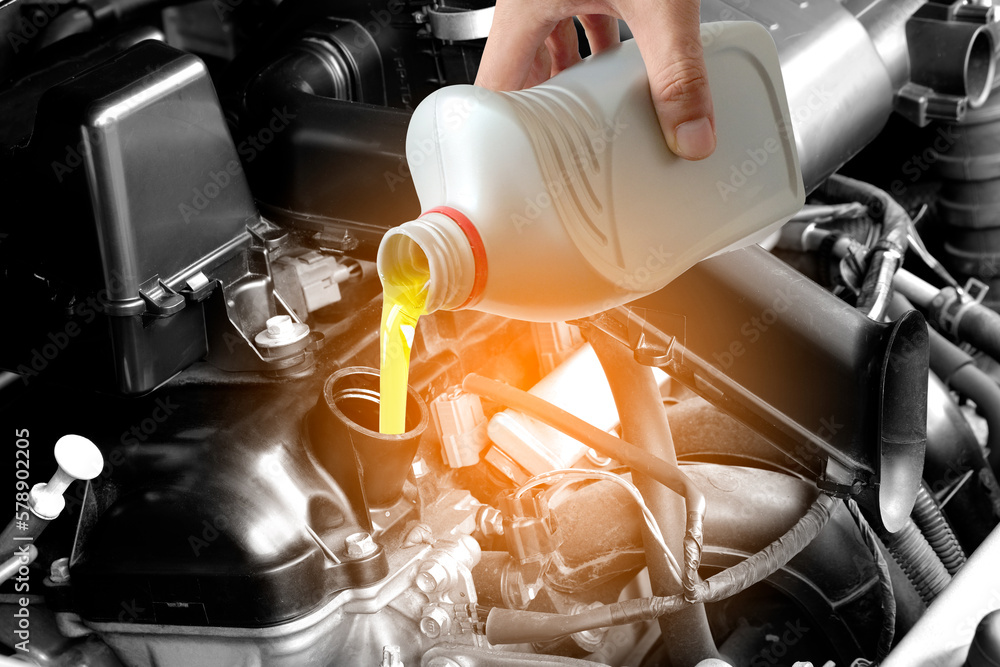 Refueling and pouring oil quality into the engine motor car ...