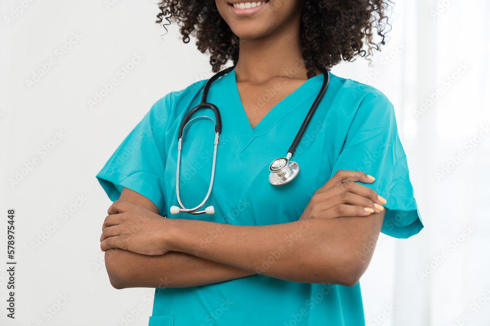 Female doctor wearing blue scrubs uniform and holding stethoscope on ...