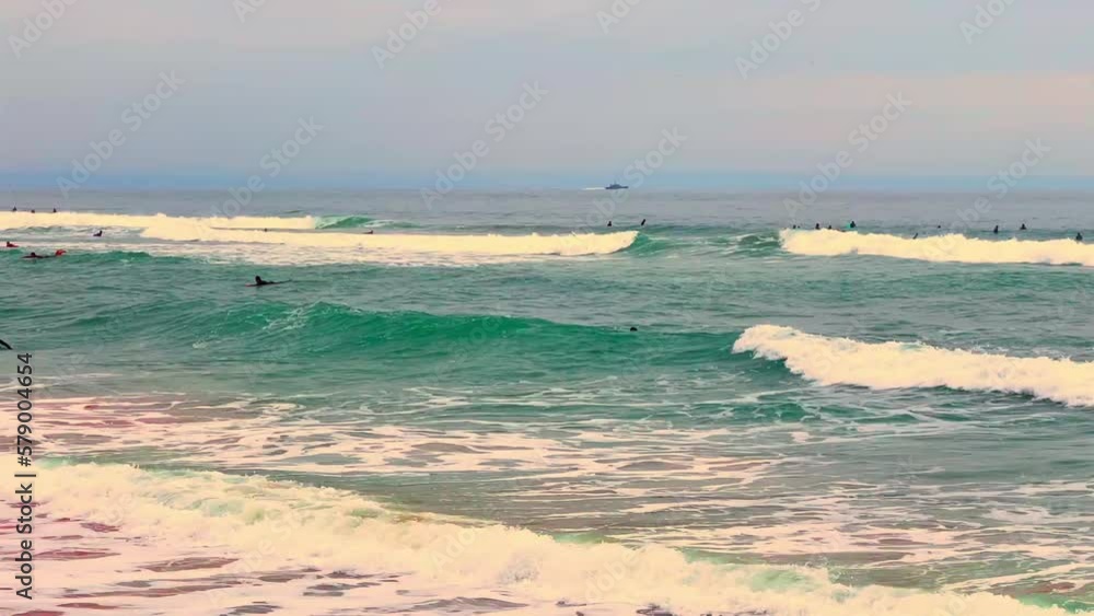Shots of surfers hanging out on the beach, sharing stories and tips ...