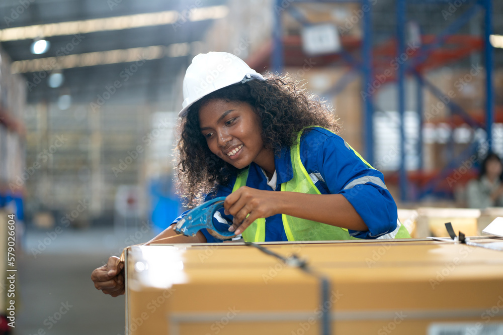Foto Stock Multiracial warehouse worker is packing cardboard box as ...