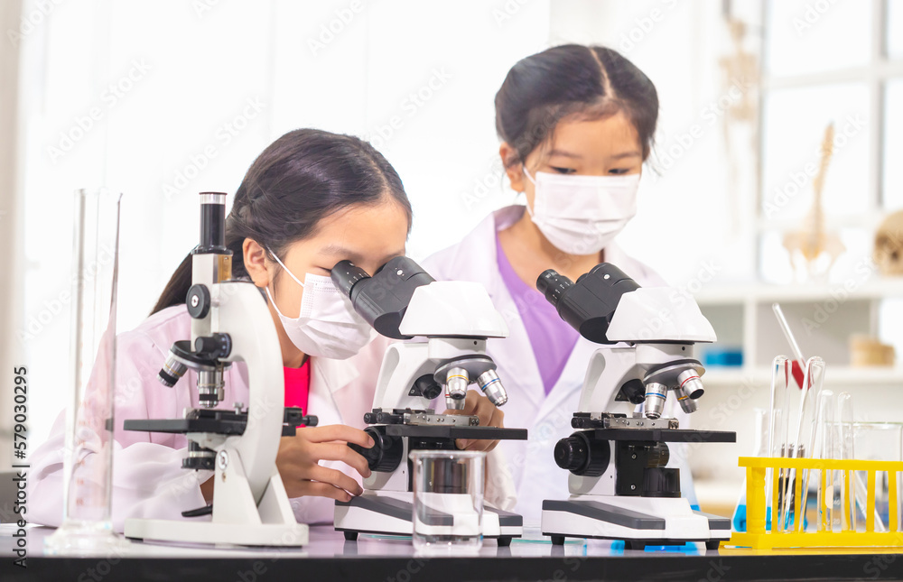 Elementary science class, Cheerful kids girl in school laboratory ...