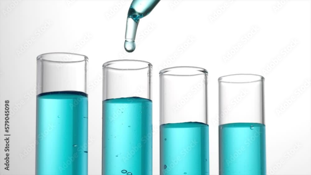 Four test tubes containing blue liquid inside are in a row and liquid ...