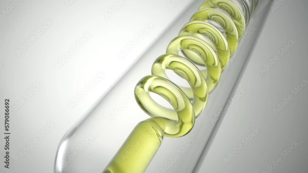 Colored fluid flowing through a glass test tube. Close up. Laboratory ...