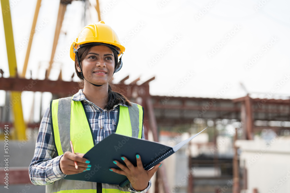 Foto de Asian woman engineer holding document smiling at construction ...