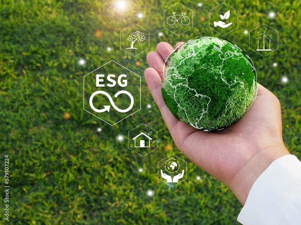 Green earth in human hand on a green field background, the concept of ...
