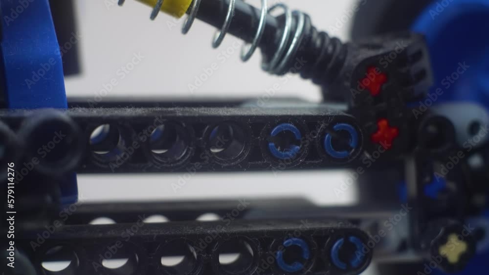 Close up demonstration of suspension strength on chassis of toy car ...