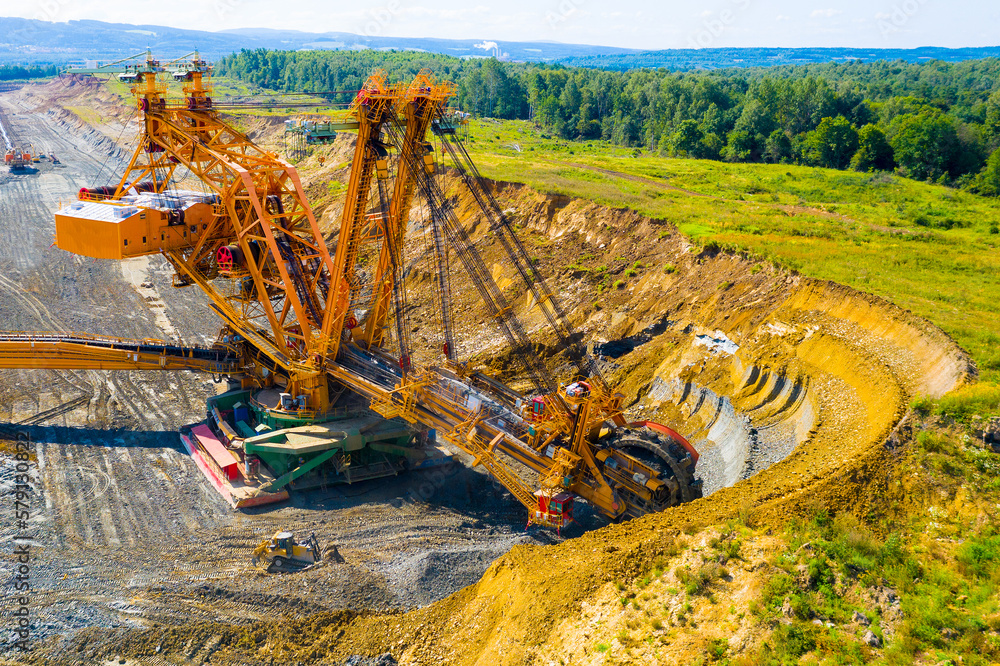 Bucket wheel excavator at work in coal mine. Mining industry from above ...