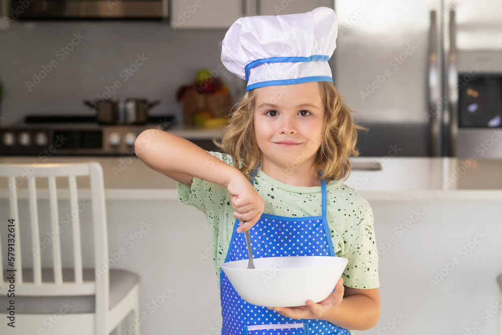 Child chef cook with cooking plate. Children cooking in the kitchen ...