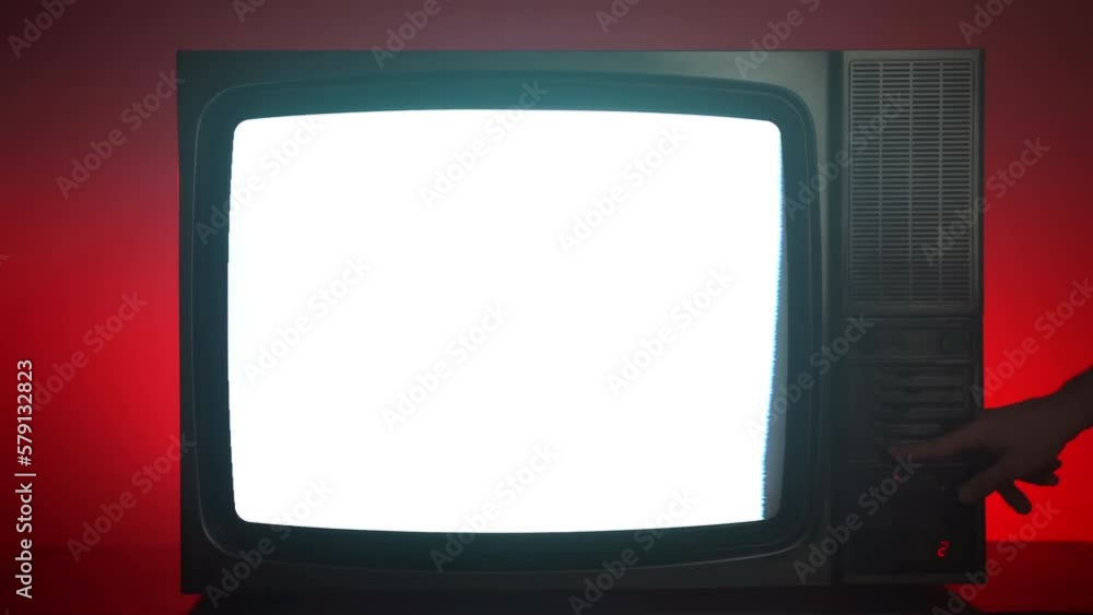 Retro TV on dark red illuminated background, antique television with ...