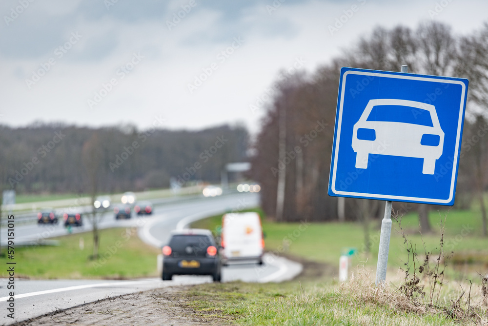 Foto de Limited acces road sign next to road entered by car and van do ...