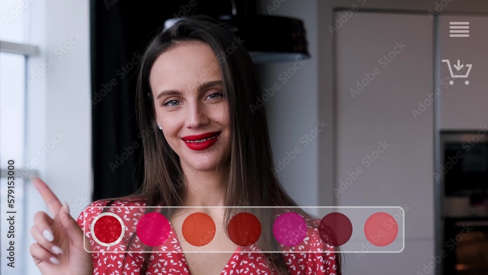 A beautiful woman chooses a lipstick color in a virtual store menu with ...