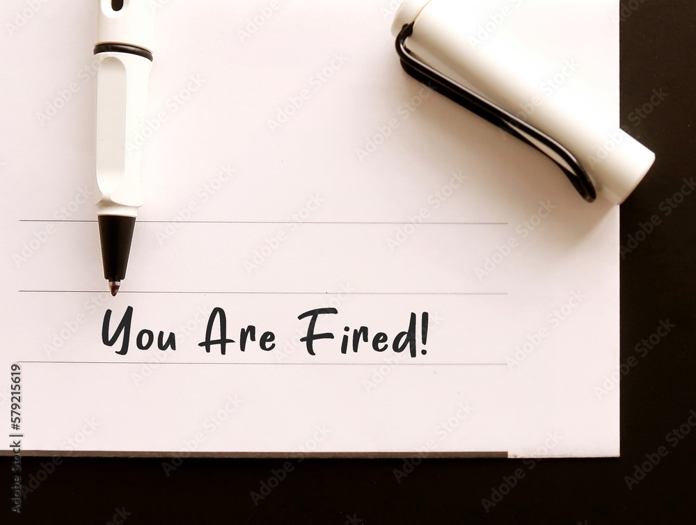 Pen writing on white office envelope YOU ARE FIRED!, means worker ...