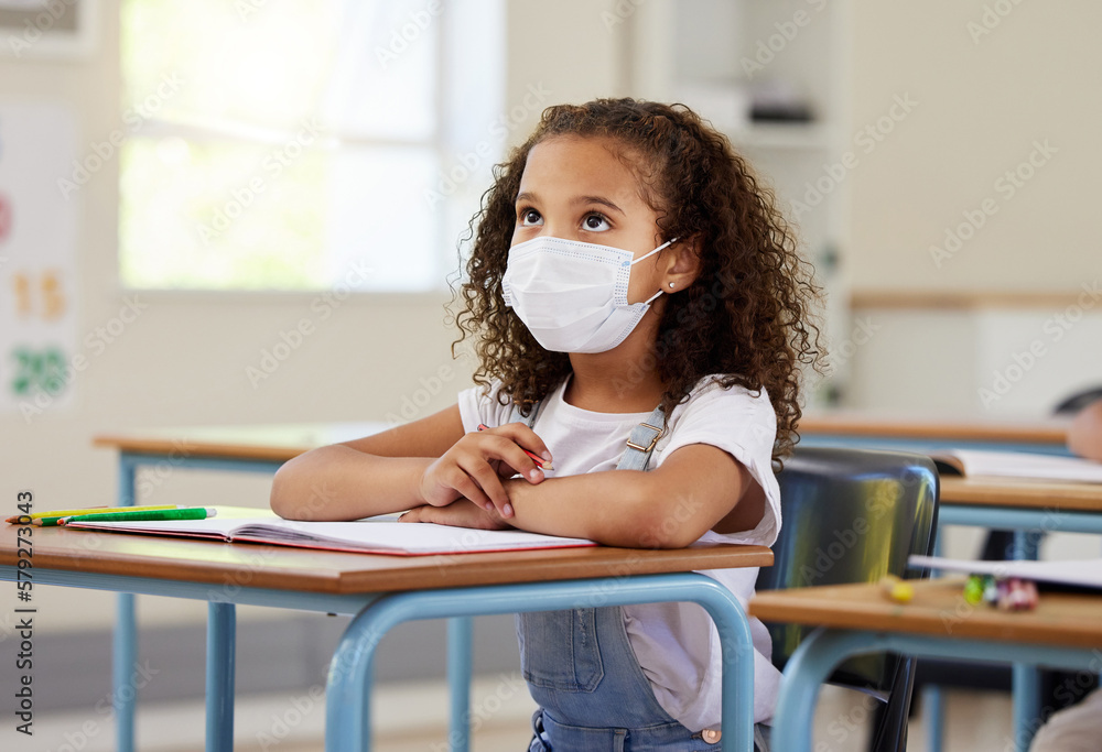 Child or student in class during covid, wearing a mask for hygiene and ...