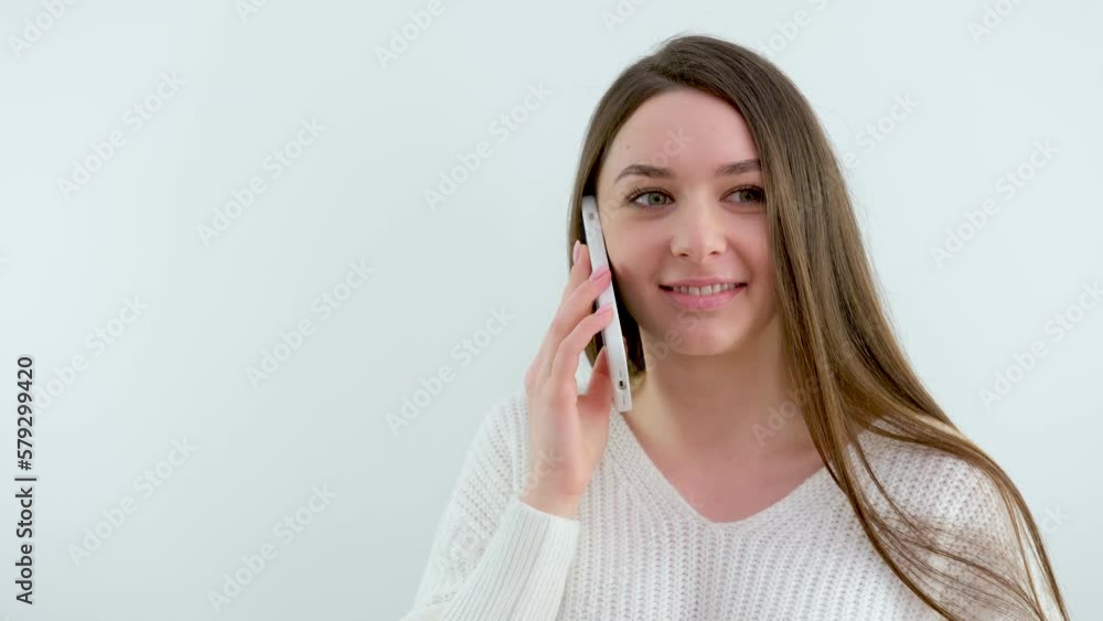 beautiful girl turns phone in her hands from a horizontal position to a ...