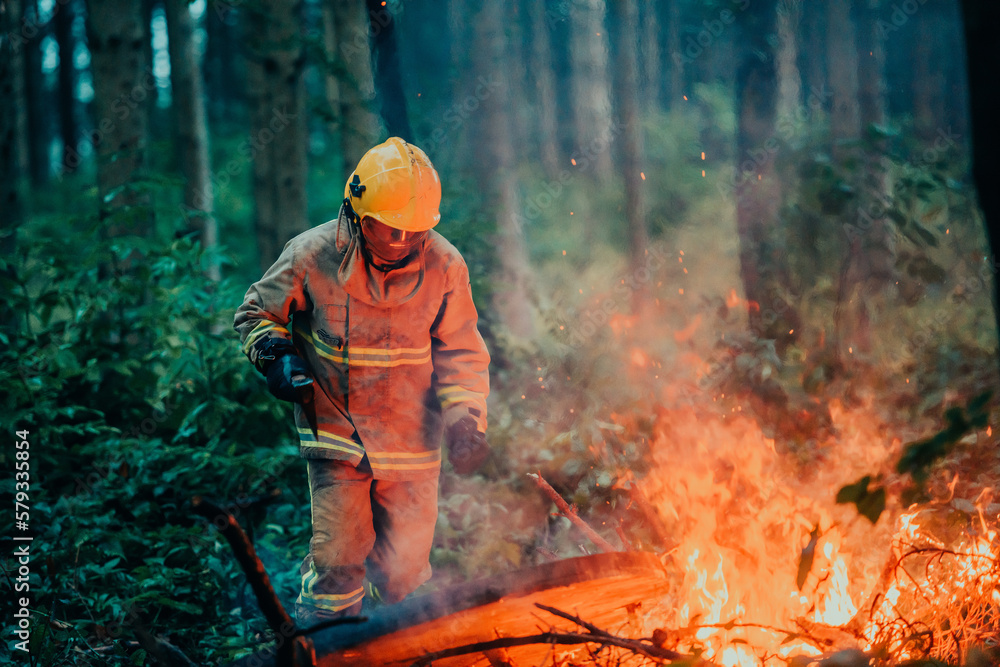 firefighter hero in action danger jumping over fire flame to rescue and ...