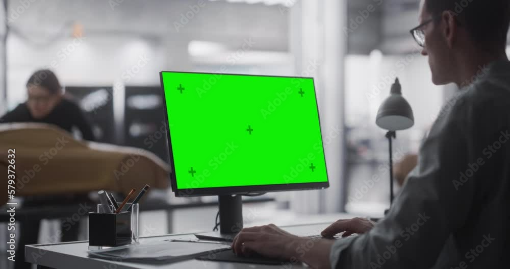 Automotive Designer Working on a Desktop Computer with Green Screen Chroma Key Mock Up Display ...