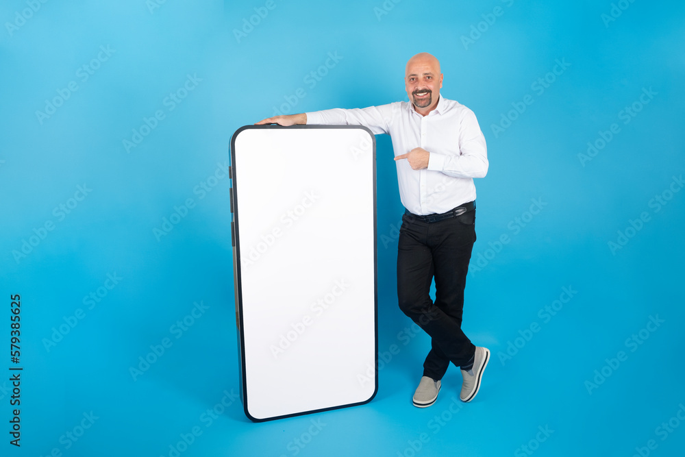 Big huge smartphone, full body length of happy man leaning big huge ...