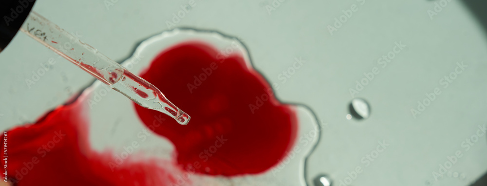 Banner. Red liquid with a pipette in the form of a spot in the ...