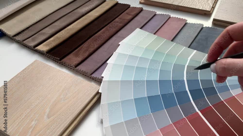 Top view: female interior designer chooses from color palette the best ...