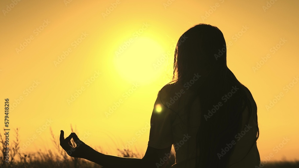 yoga hand sign. girl sunset doing yoga. female meditation glare sun ...