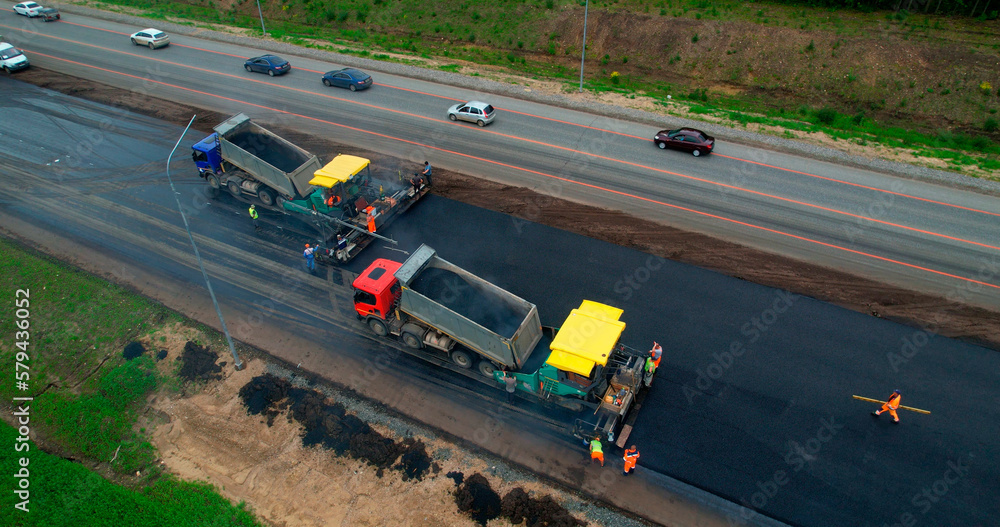 Road construction works aerial view. Laying of new asphalt on the road ...