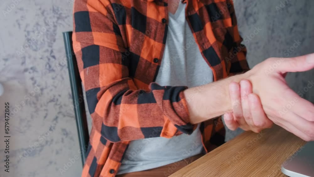 Man suffer wrist joint pain while working on laptop computer at home ...