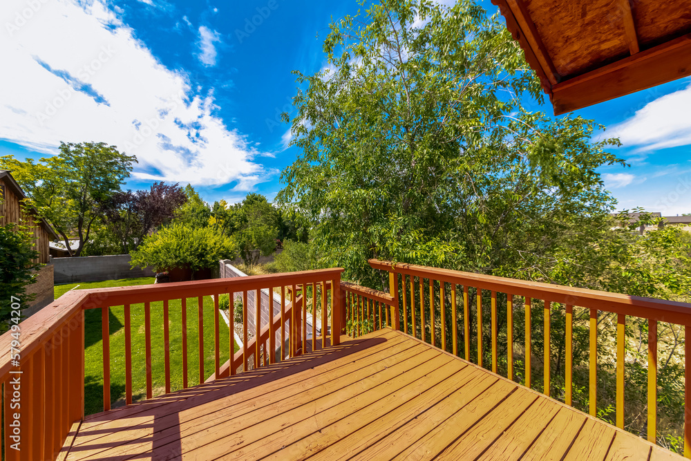 Upper deck of a house with outdoor staircase that leads down to the ...