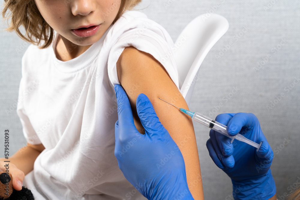 vaccination of children, a little boy at a doctor's appointment, an ...