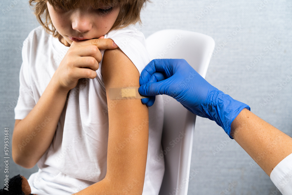 vaccination of children, a little boy at a doctor's appointment, an ...