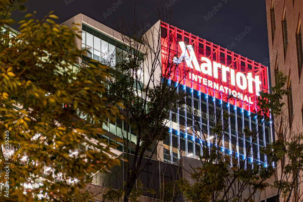 A Marriott International sign is illuminated atop Marriott's new ...
