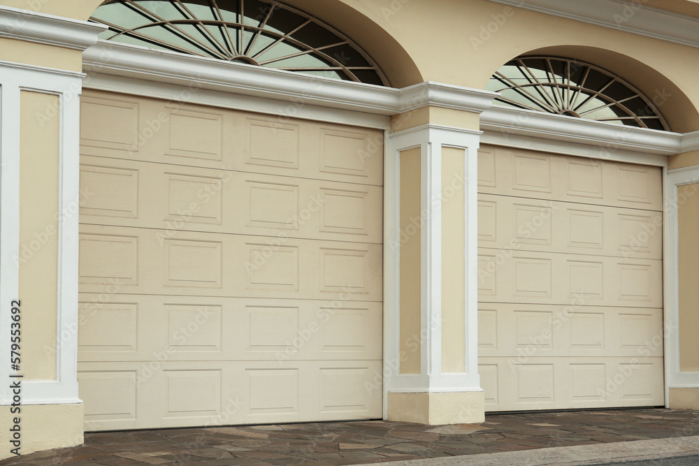 Building with beige sectional garage doors outdoors Stock Photo | Adobe ...