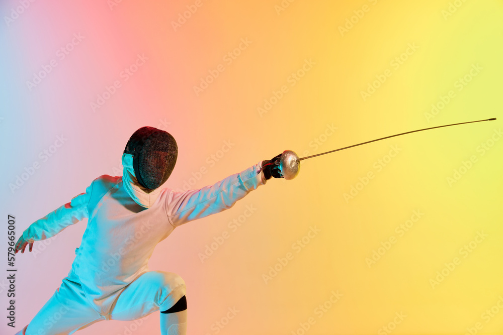 Young man, male fencer with sword practicing in fencing over gradient ...