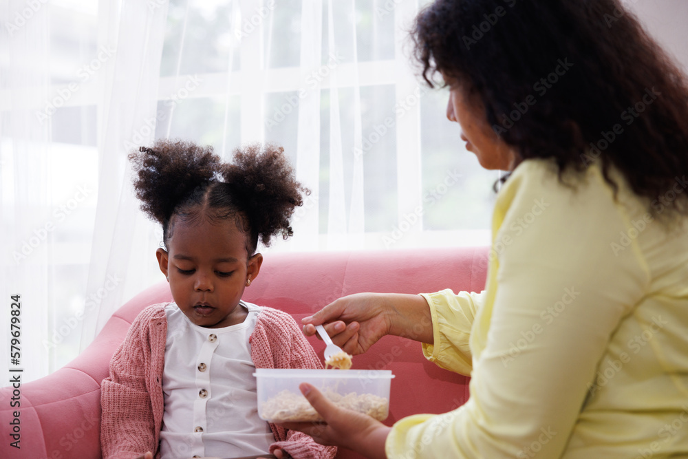 unhappy little african girl child boring with the meal in the white ...