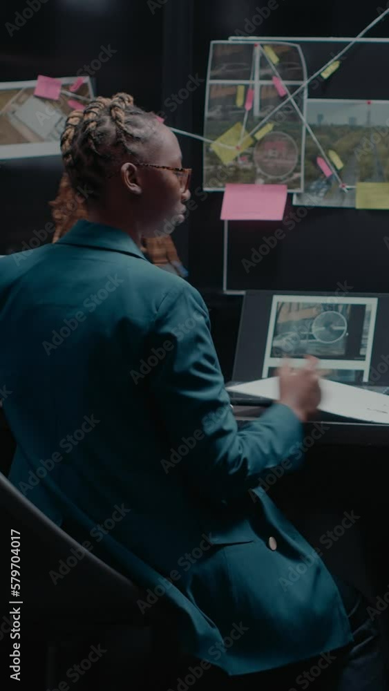 Vertical video: Police investigator examining clues from crime scene ...