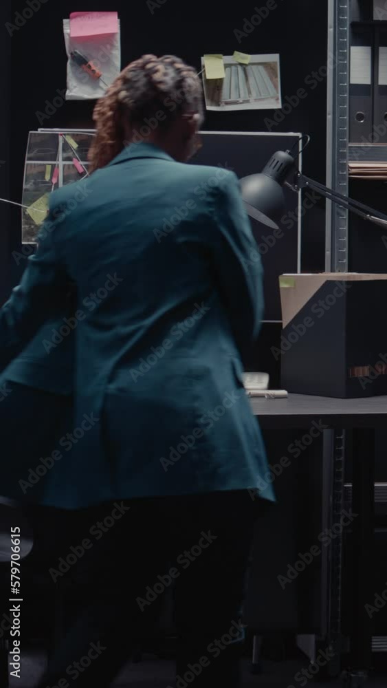 Vertical video: Private inspector examining clues and records ...