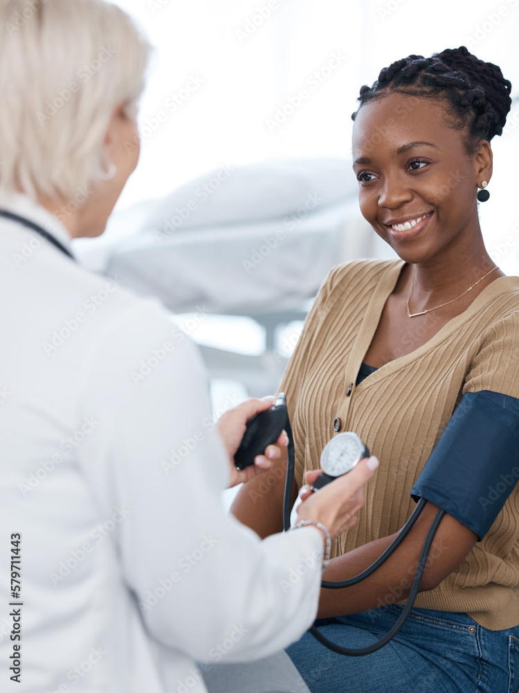 Blood pressure, doctor and black woman patient smile in hospital for ...