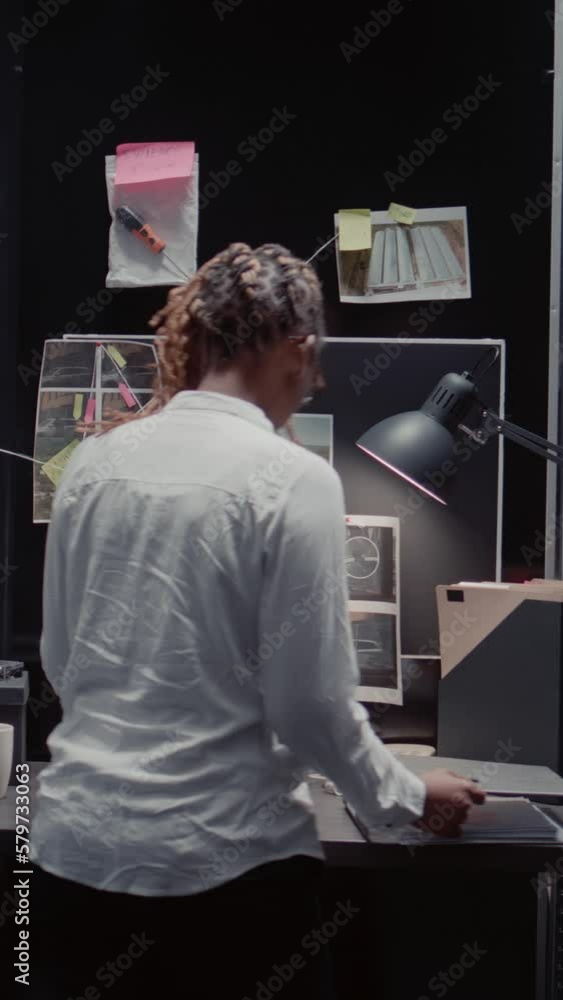 Vertical video: Law officer uncovering details and important clues on ...