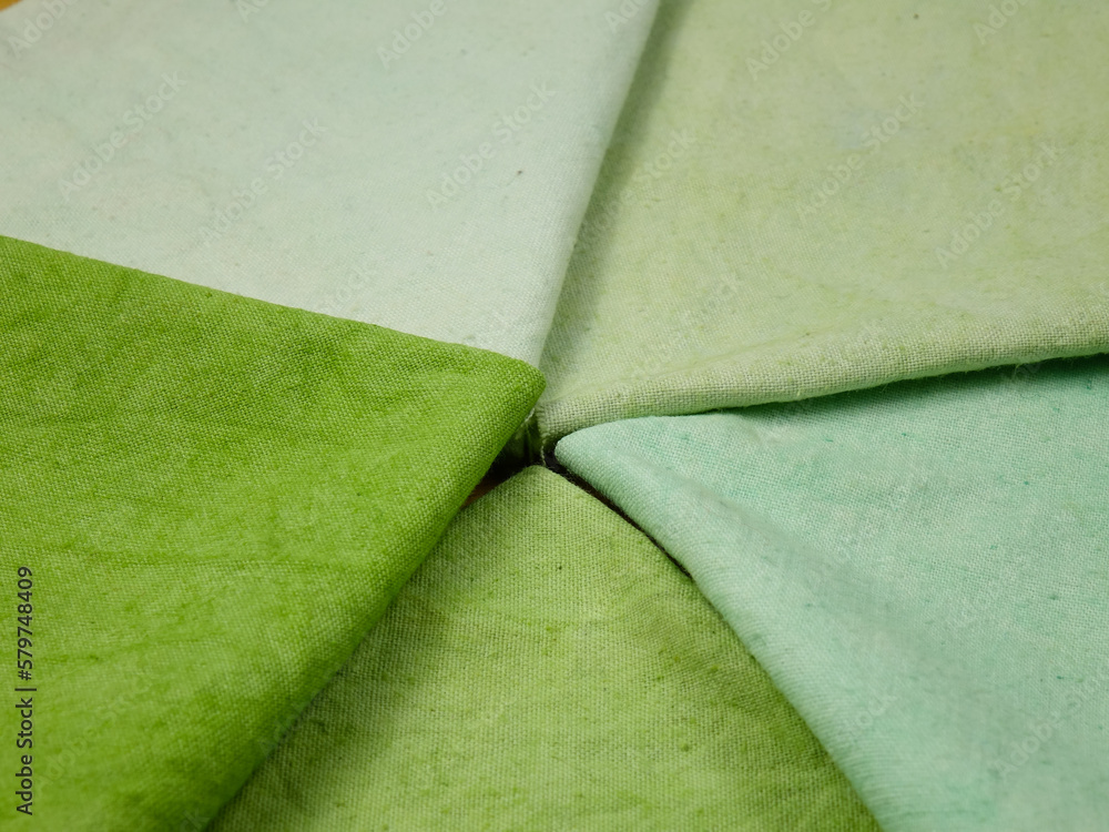 Samples of cotton fabric with gradient in green tones, background ...