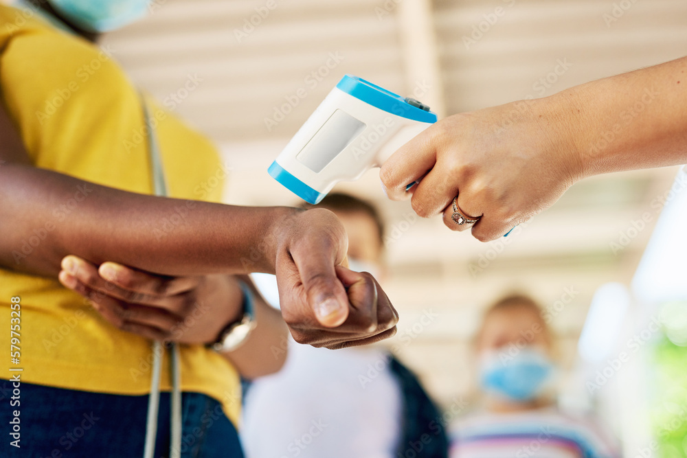Every child gets a temperature check. Cropped shot of an unrecognizable ...